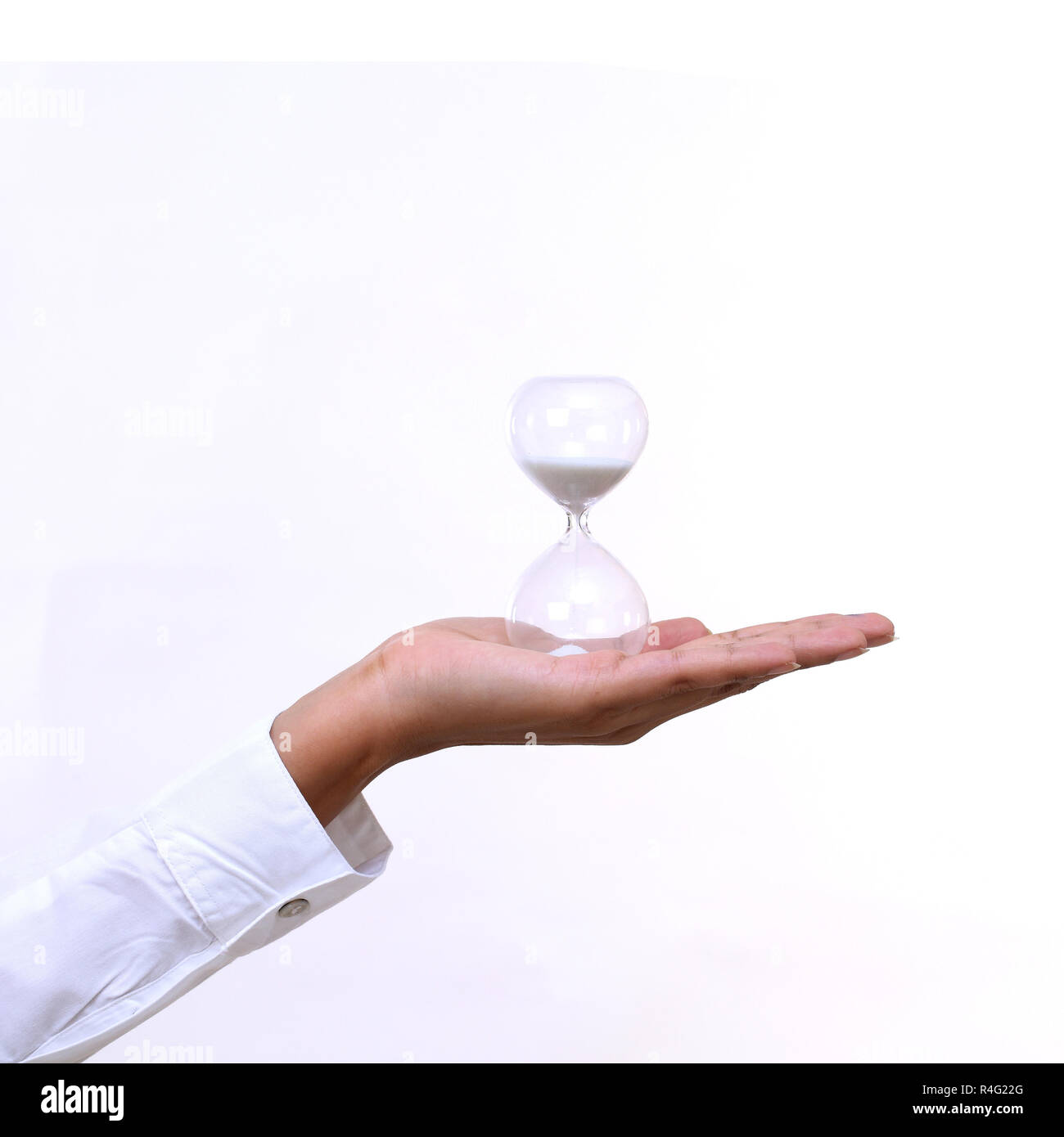 Business woman hand holding a hourglass Stock Photo - Alamy