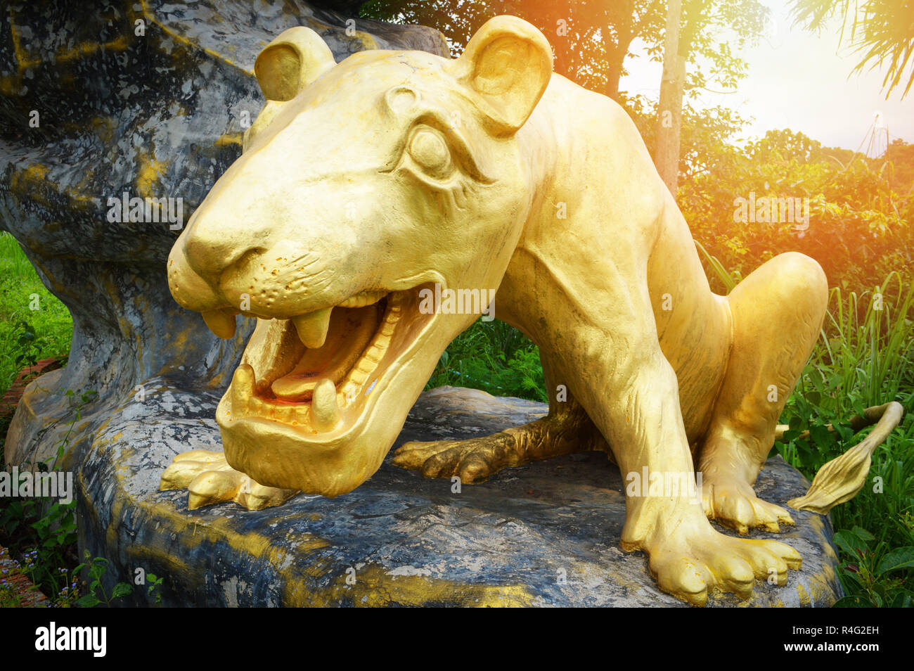 golden lion statue / the large statue of lion golden on the rock in the ...
