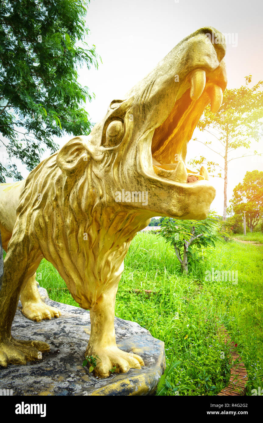 golden lion statue / the large statue of lion golden on the rock in the ...
