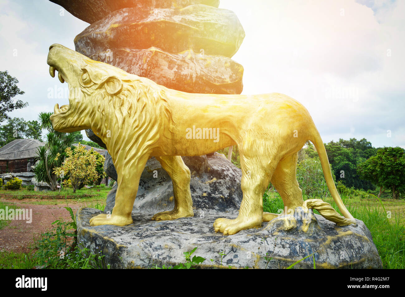 golden lion statue / the large statue of lion golden on the rock in the ...