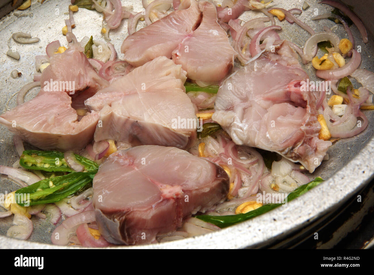 Cooking of fish curry Stock Photo - Alamy