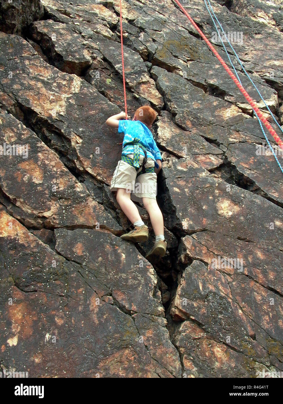 boy climbing on rope Stock Photo - Alamy