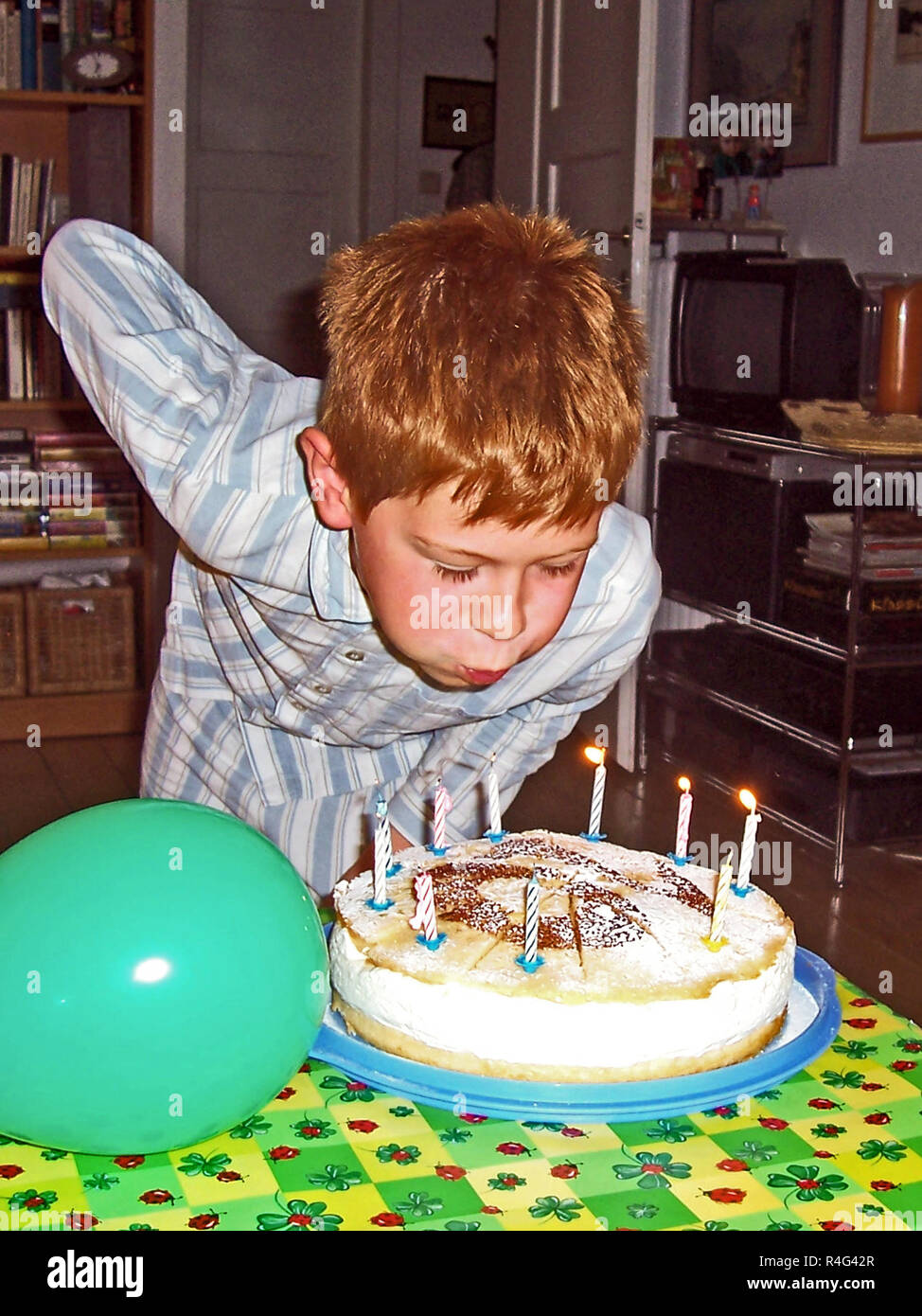 boy blowing out his birthday candles Stock Photo - Alamy