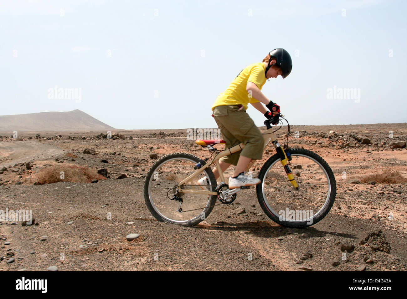 boy riding his mountainbike offroads and doing tricks Stock Photo - Alamy