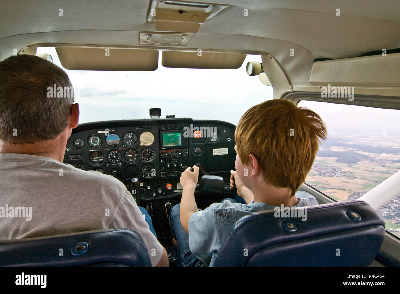 joung boy is flying aircraft assisted by a trainer Stock Photo - Alamy