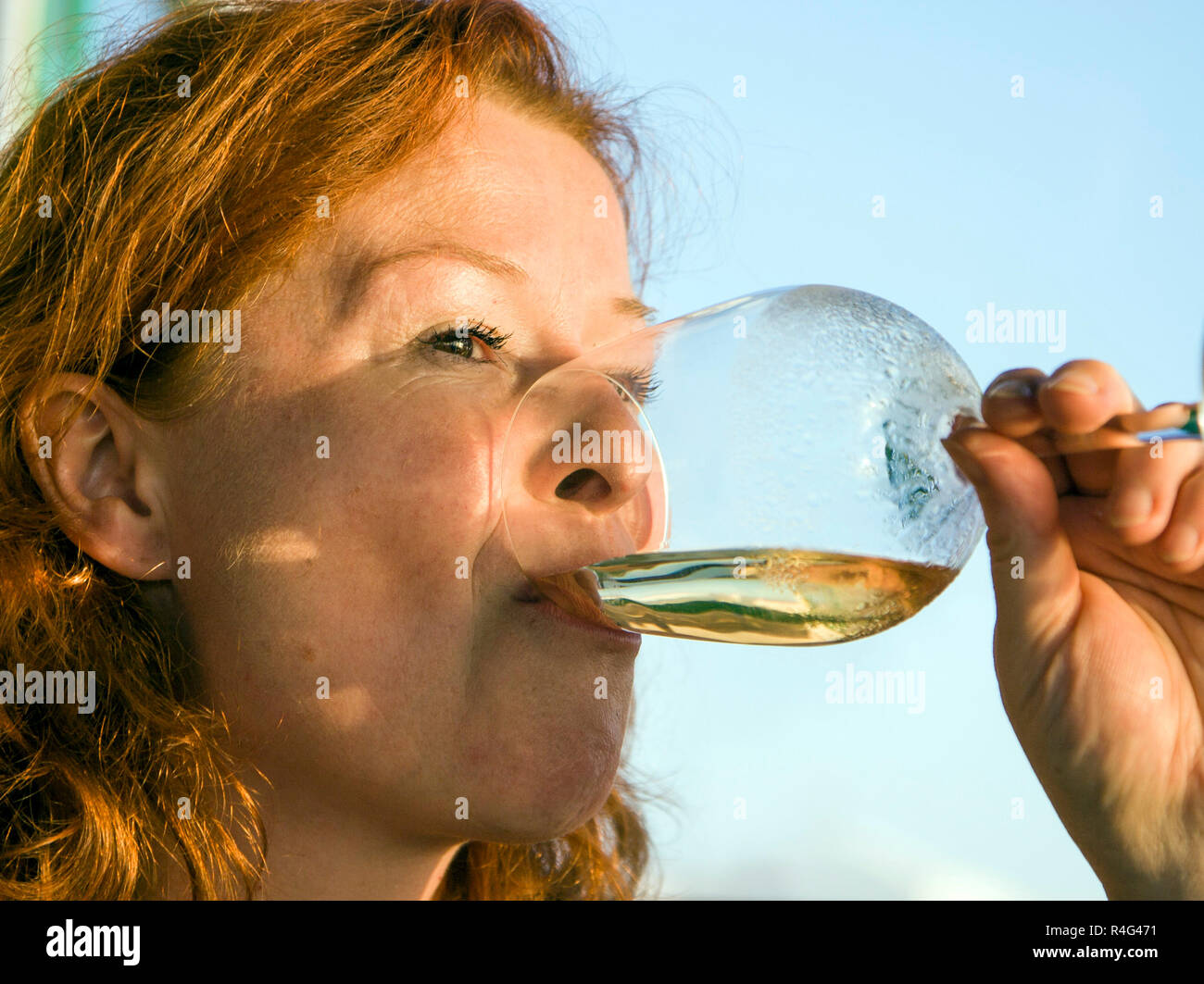 woman drinking white wine Stock Photo - Alamy