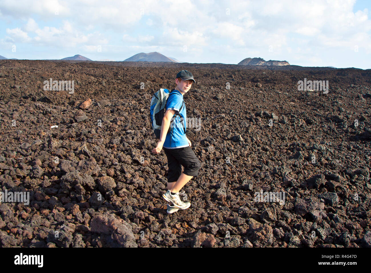 boy on walking trail in volcanic area in Lanzarote Stock Photo - Alamy