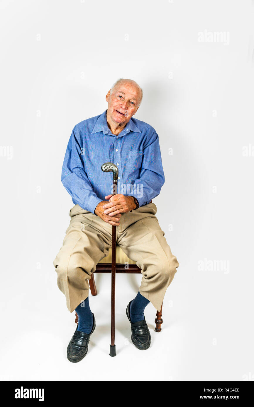 happy elderly man sitting in a chair Stock Photo - Alamy