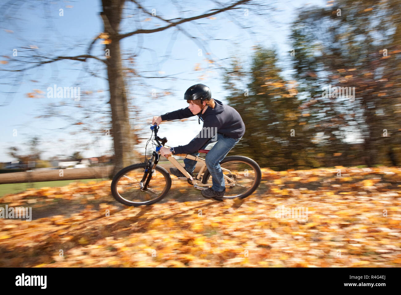 young boy is riding with the dirtbike and racing in the landscape ...