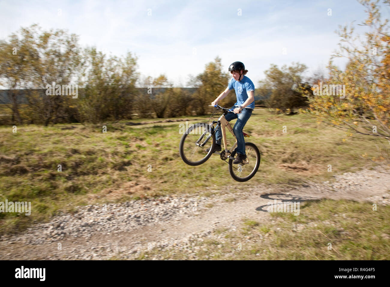 young boy is riding with the dirtbike and racing in the landscape ...
