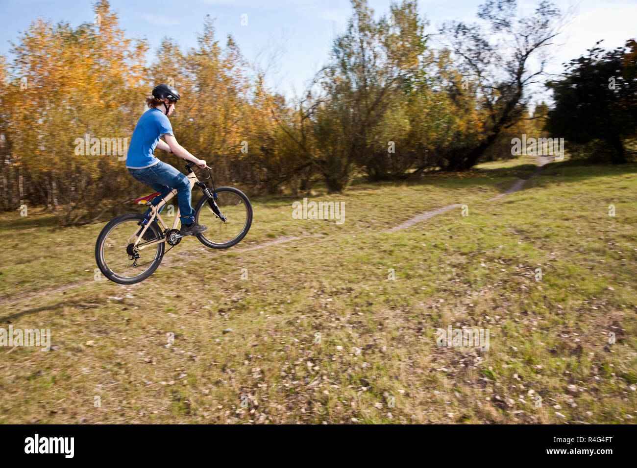 young boy is riding with the dirtbike and racing in the landscape ...