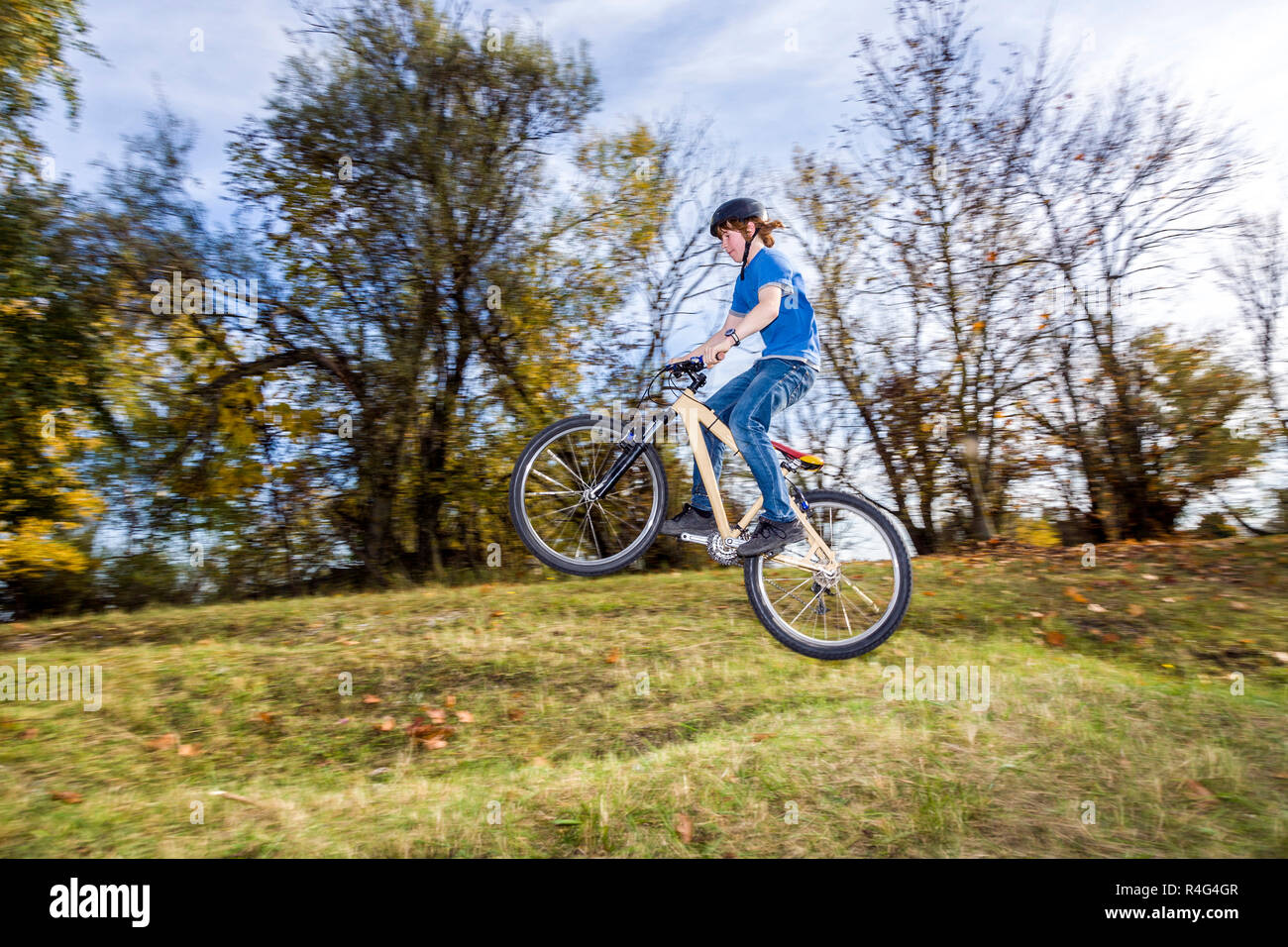 boy jumps over a ramp with his dirt bike Stock Photo - Alamy