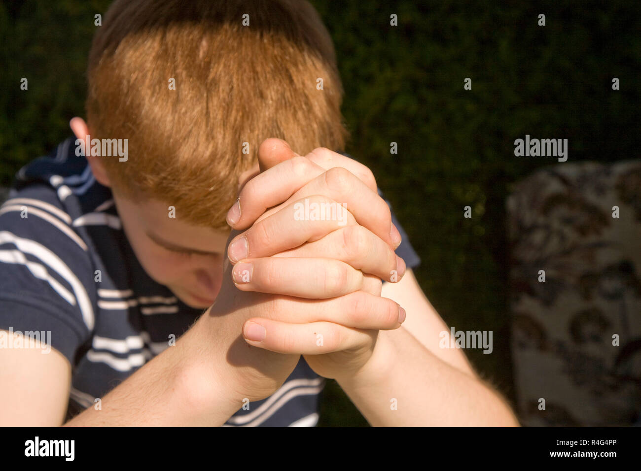 young red haired boy has his hands folded Stock Photo - Alamy