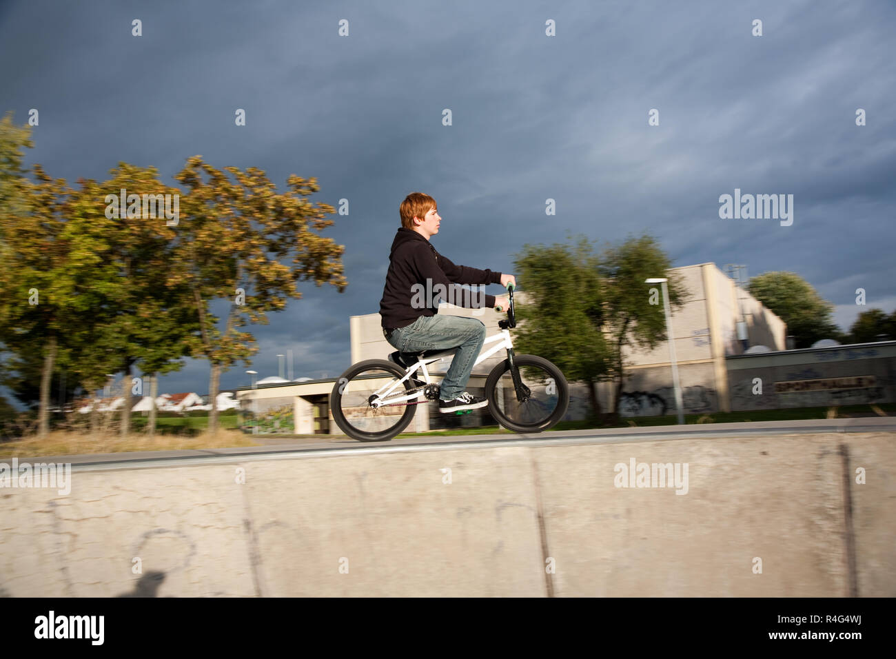 joung red haired boy is jumping with his BMX Bike Stock Photo - Alamy
