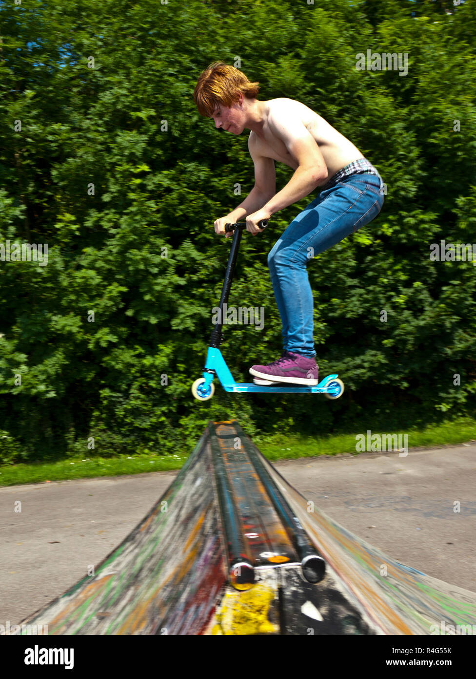 young boy going airborne with a scooter Stock Photo - Alamy