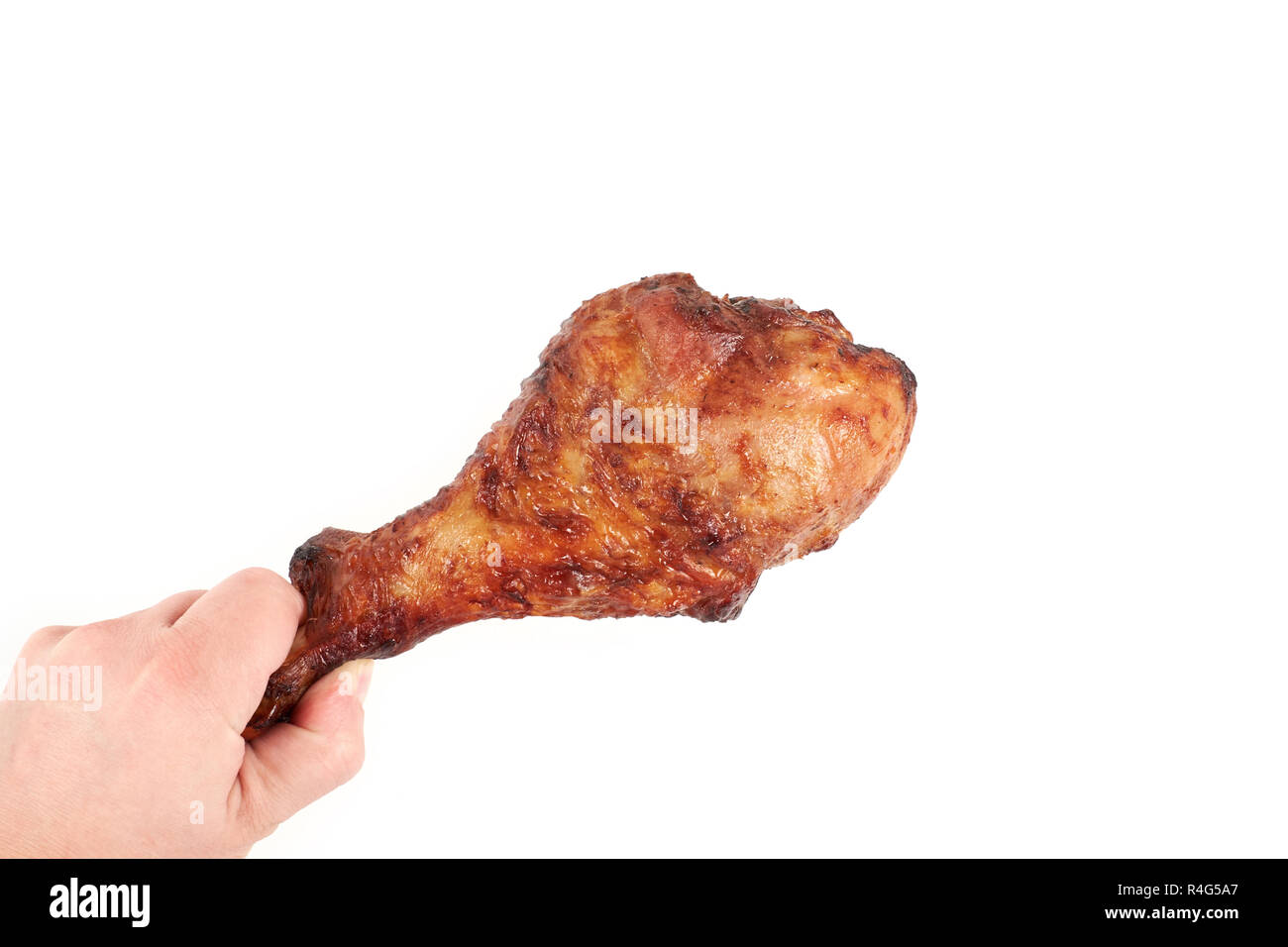 Close up and isolated image of hand holding a grilled turkey leg on ...