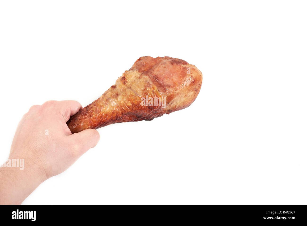 Close up and isolated image of hand holding a grilled turkey leg on ...