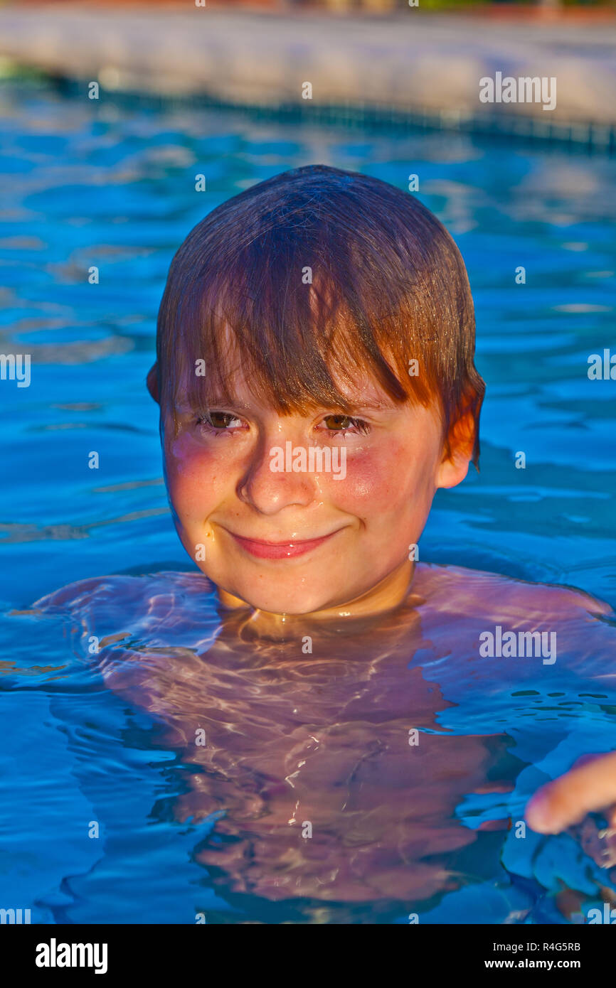 Happy teenagers jumping into outdoor pool hi-res stock photography and ...