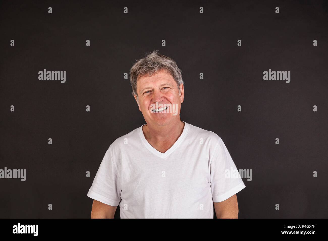 smiling happy casual dressed man in studio Stock Photo - Alamy