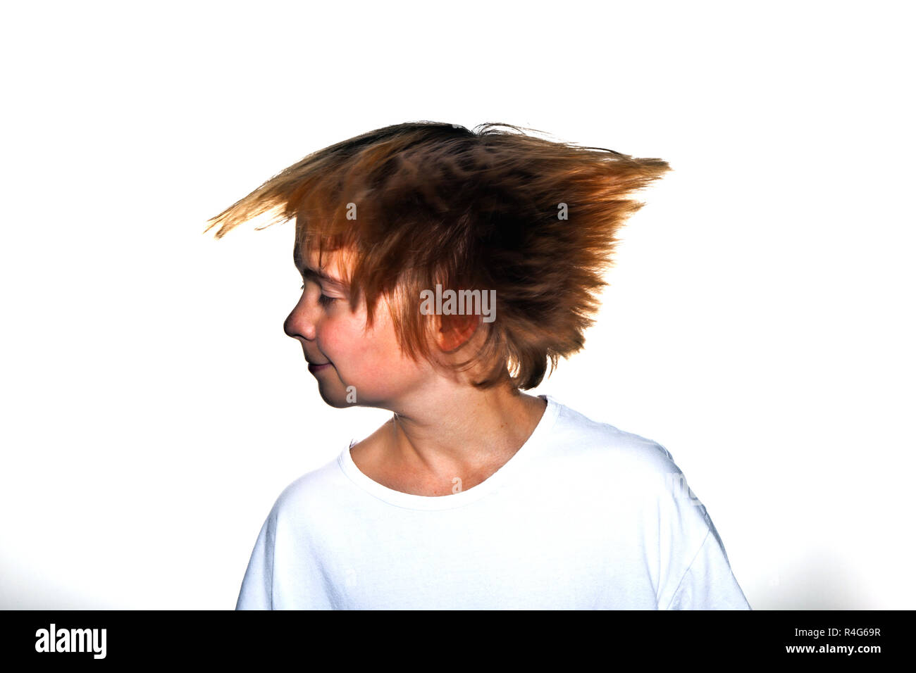 boy is moving his head and hairs are flying Stock Photo - Alamy