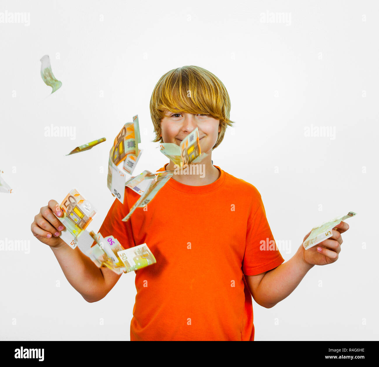 Euros flying around a boys head Stock Photo - Alamy