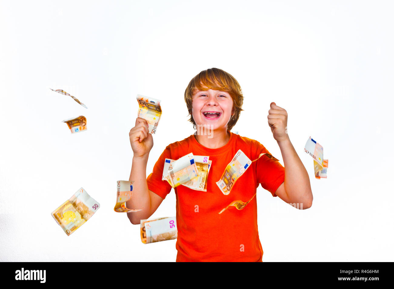 Euros flying around a boys head Stock Photo - Alamy