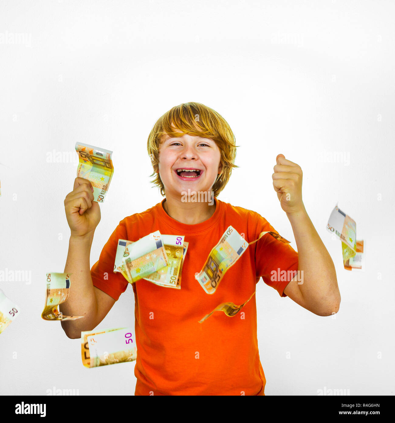 Euros flying around a boys head Stock Photo - Alamy