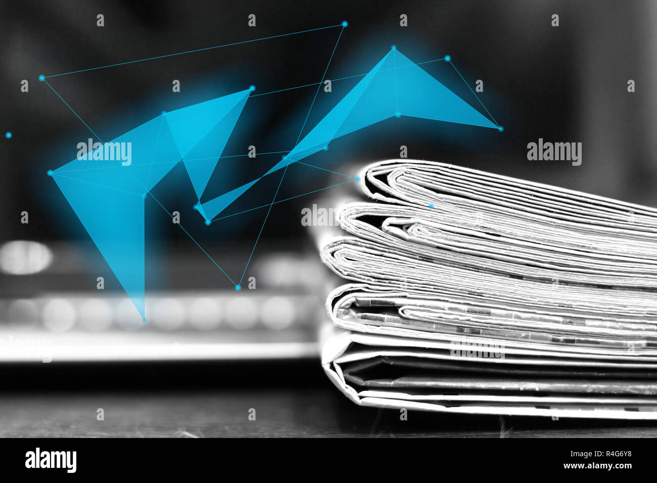 Laptop and newspapers with virtual abstract polygon projection. Digital ...
