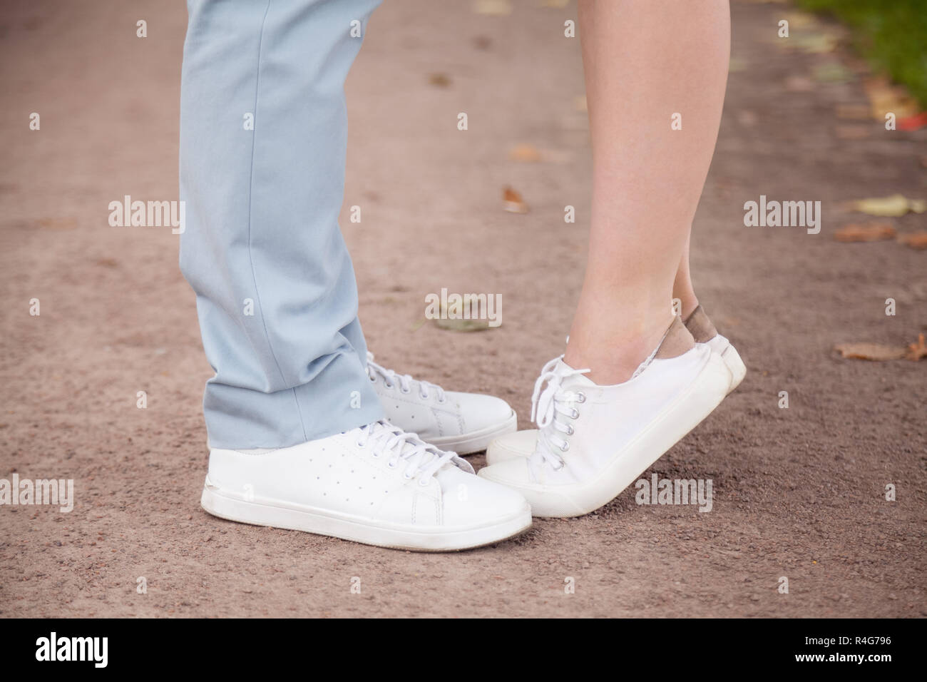 Loving woman standing tiptoe, trying kiss boyfriend outdoors Stock ...