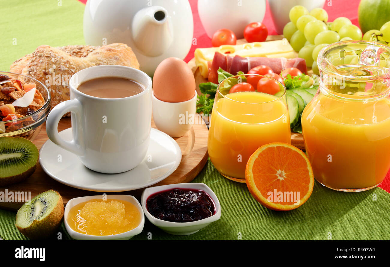 Breakfast served with coffee, orange juice, egg and fruits Stock Photo ...