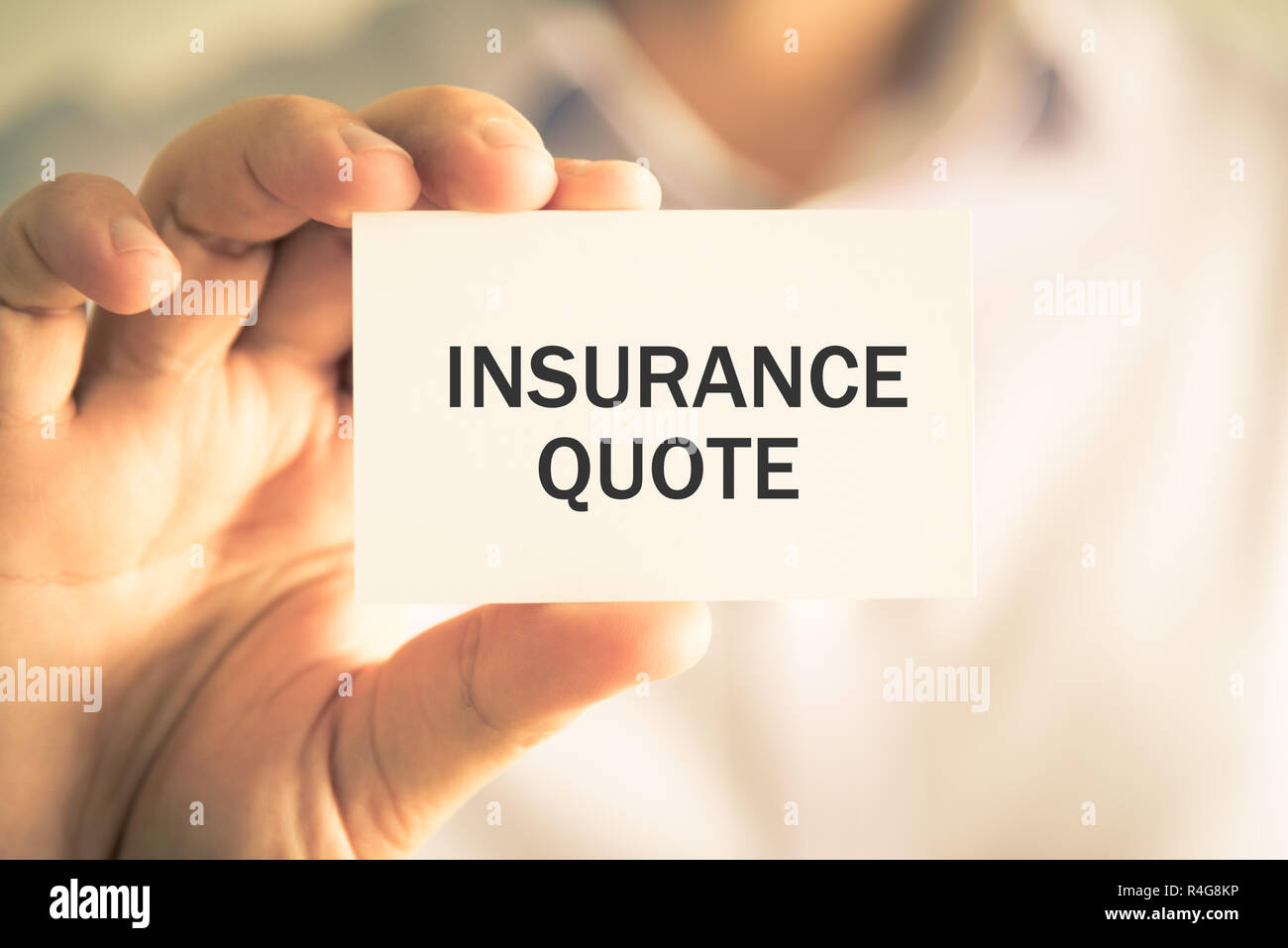 Businessman holding INSURANCE QUOTE message card Stock Photo - Alamy