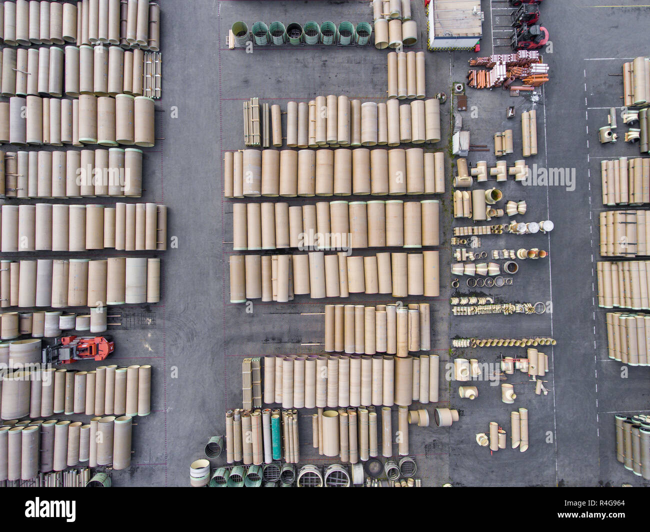 Industrial concrete drainage pipes stacked for construction. New tubes ...