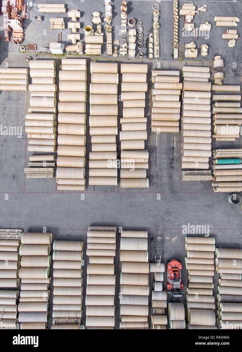 Industrial concrete drainage pipes stacked for construction. New tubes ...