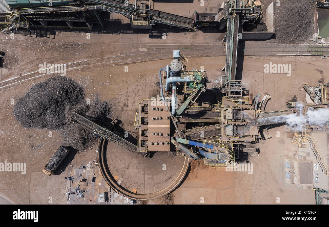 Iron raw materials recycling pile, work machines. Metal waste junkyard ...