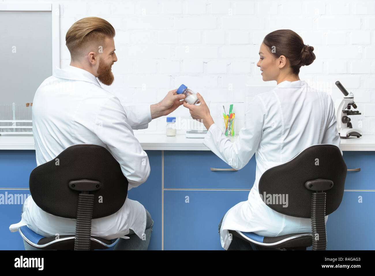 back view of scientists working with analysis in lab Stock Photo - Alamy