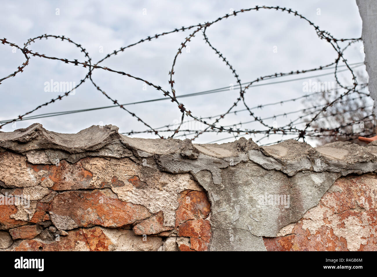 brick wall with barbed-wire Stock Photo - Alamy