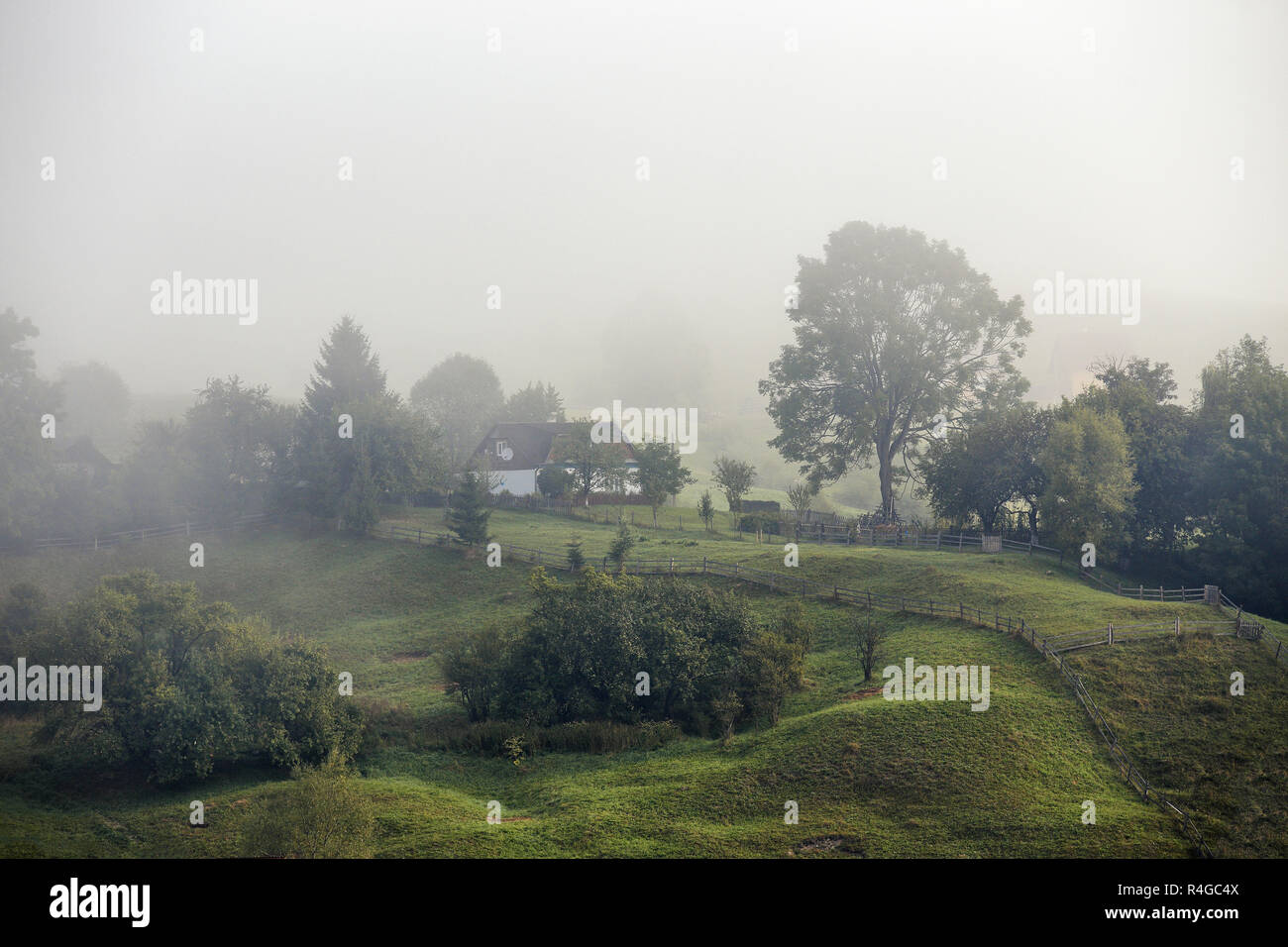 A foggy village in the carpathian mountains hi-res stock photography ...