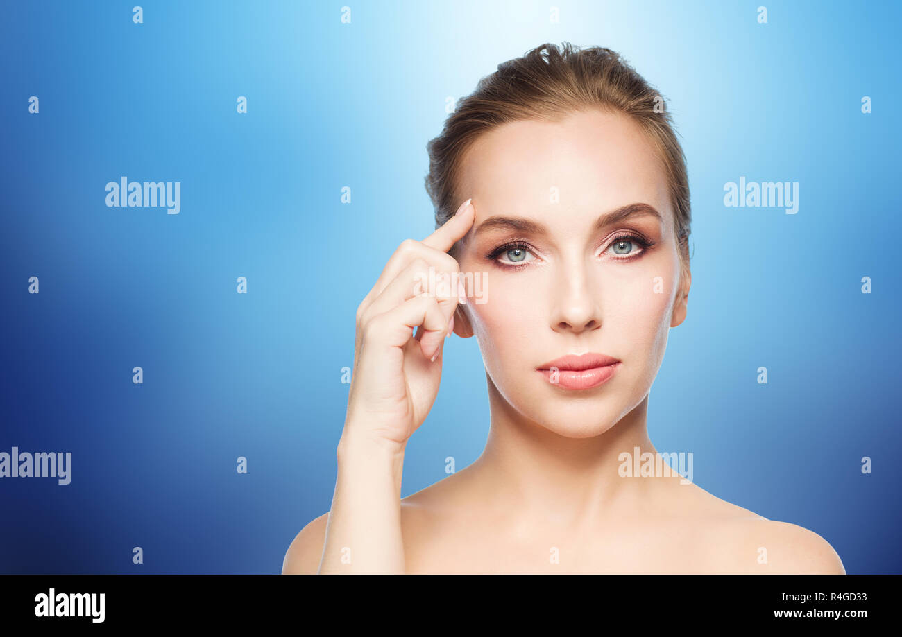 Beautiful woman pointing forehead hi-res stock photography and images ...