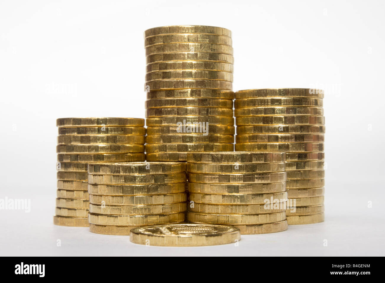 Six stacks of coins increasing in height on a white background Stock ...