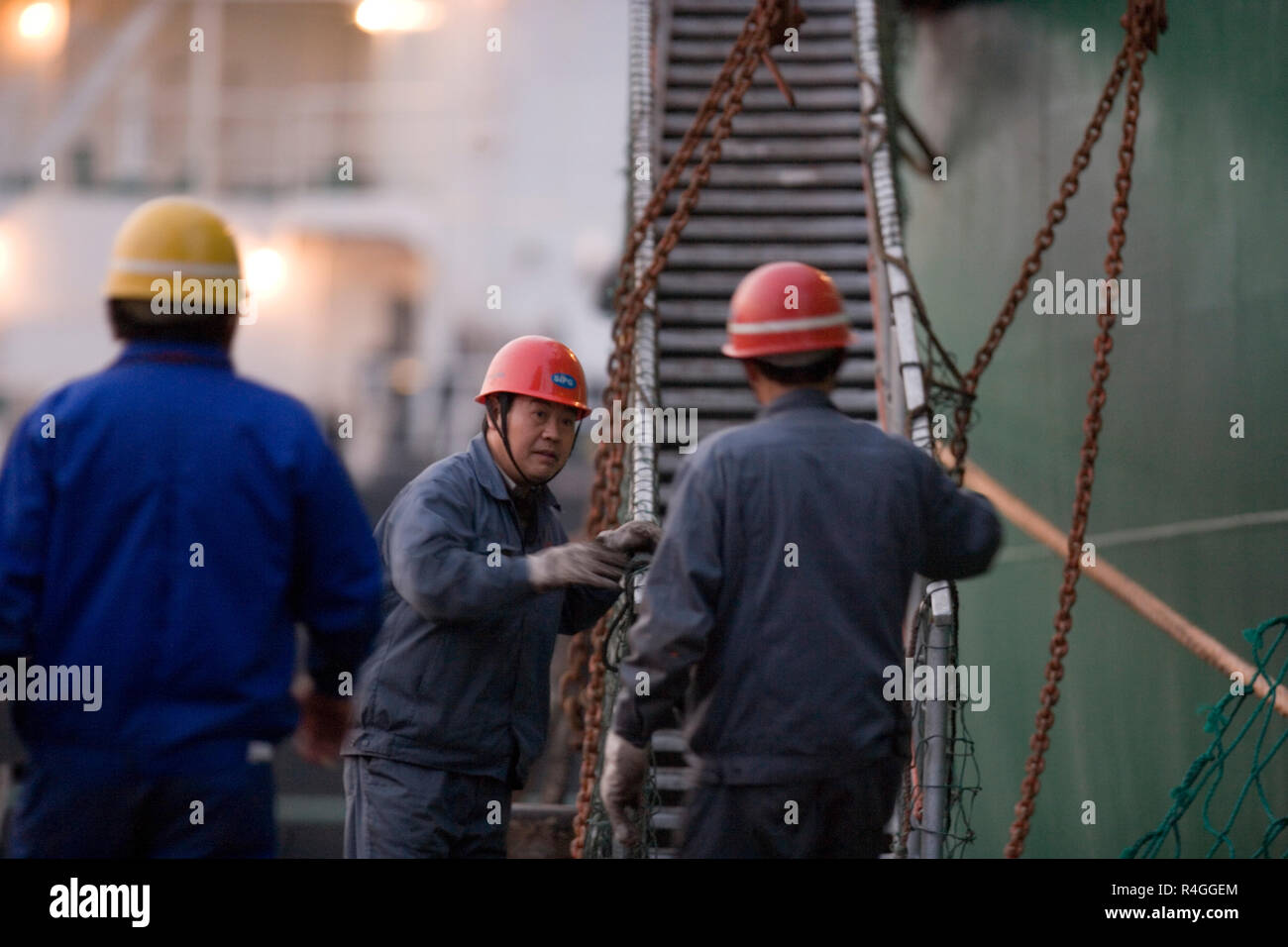 Mid-adult male construction workers working on a shipping dock Stock ...