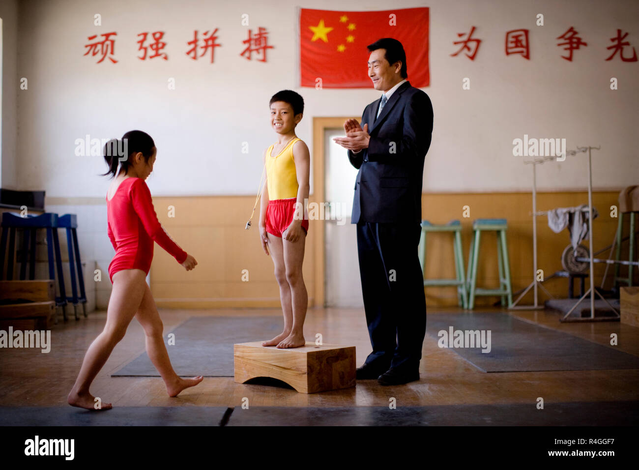 Portrait of a boy standing on a podium in a gym Stock Photo - Alamy