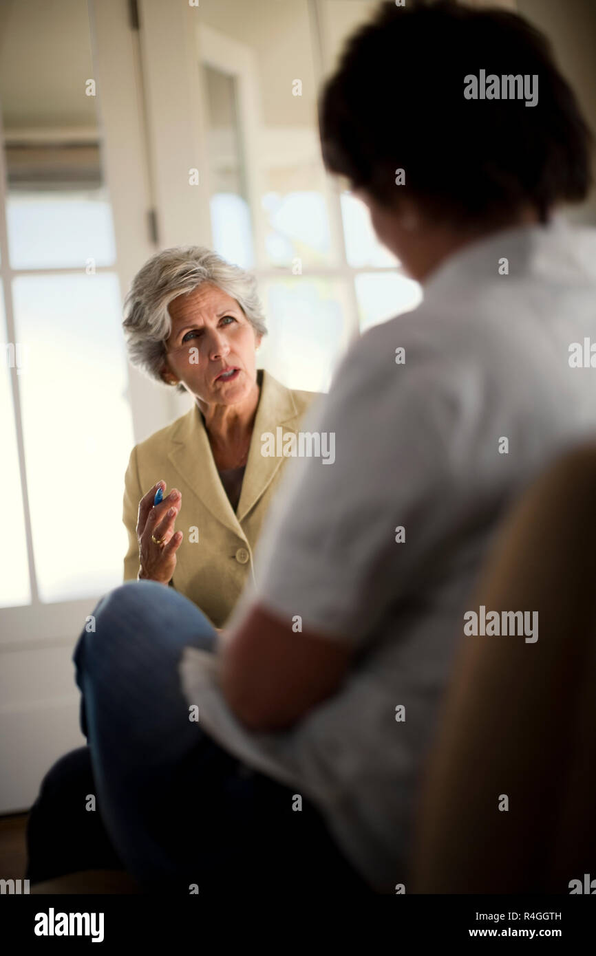 Mature female lawyer has an intense discussion with her client in her ...