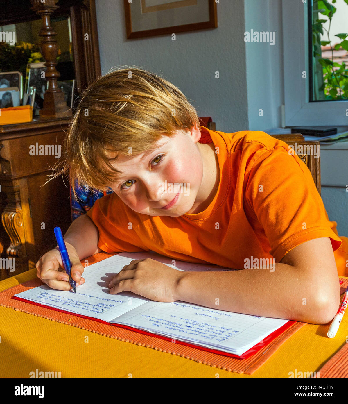 boy prepares his homework for school Stock Photo - Alamy