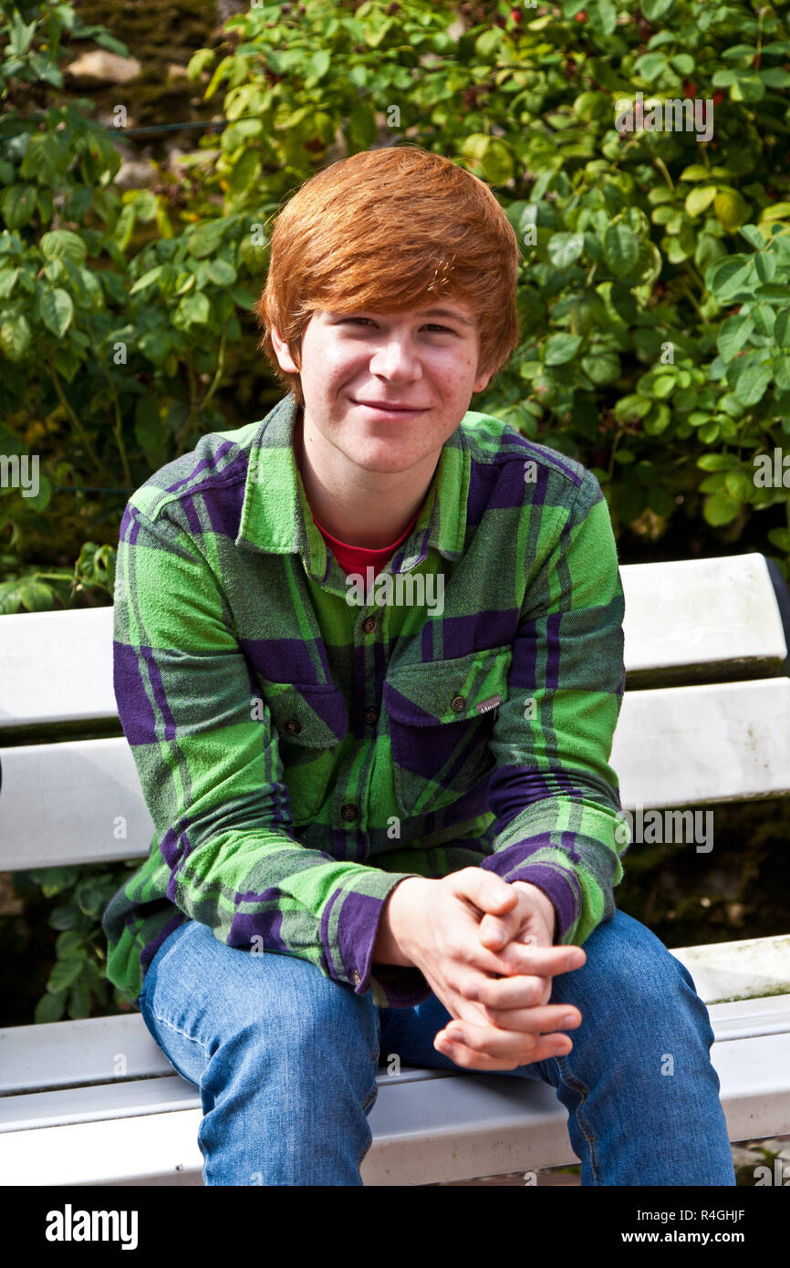 boy sitting on a bench Stock Photo - Alamy