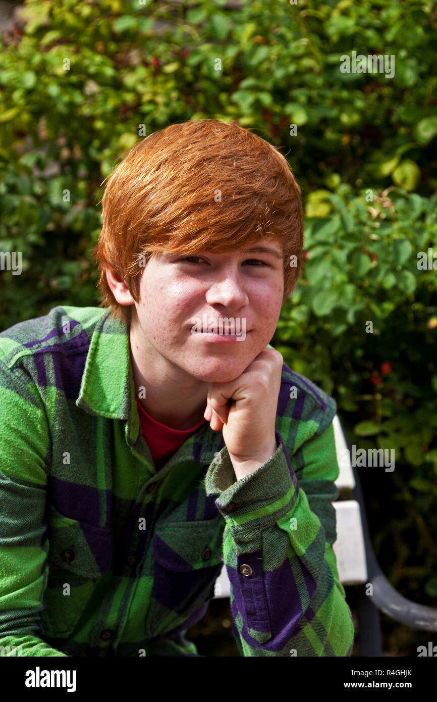 boy sitting on a bench Stock Photo - Alamy