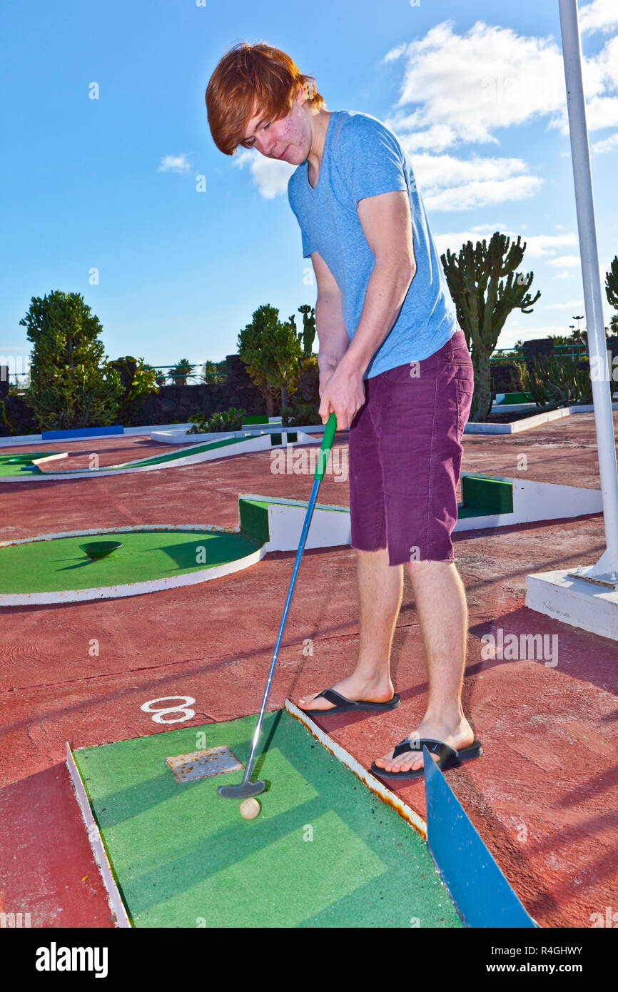 boy playing mini golf in the course Stock Photo - Alamy