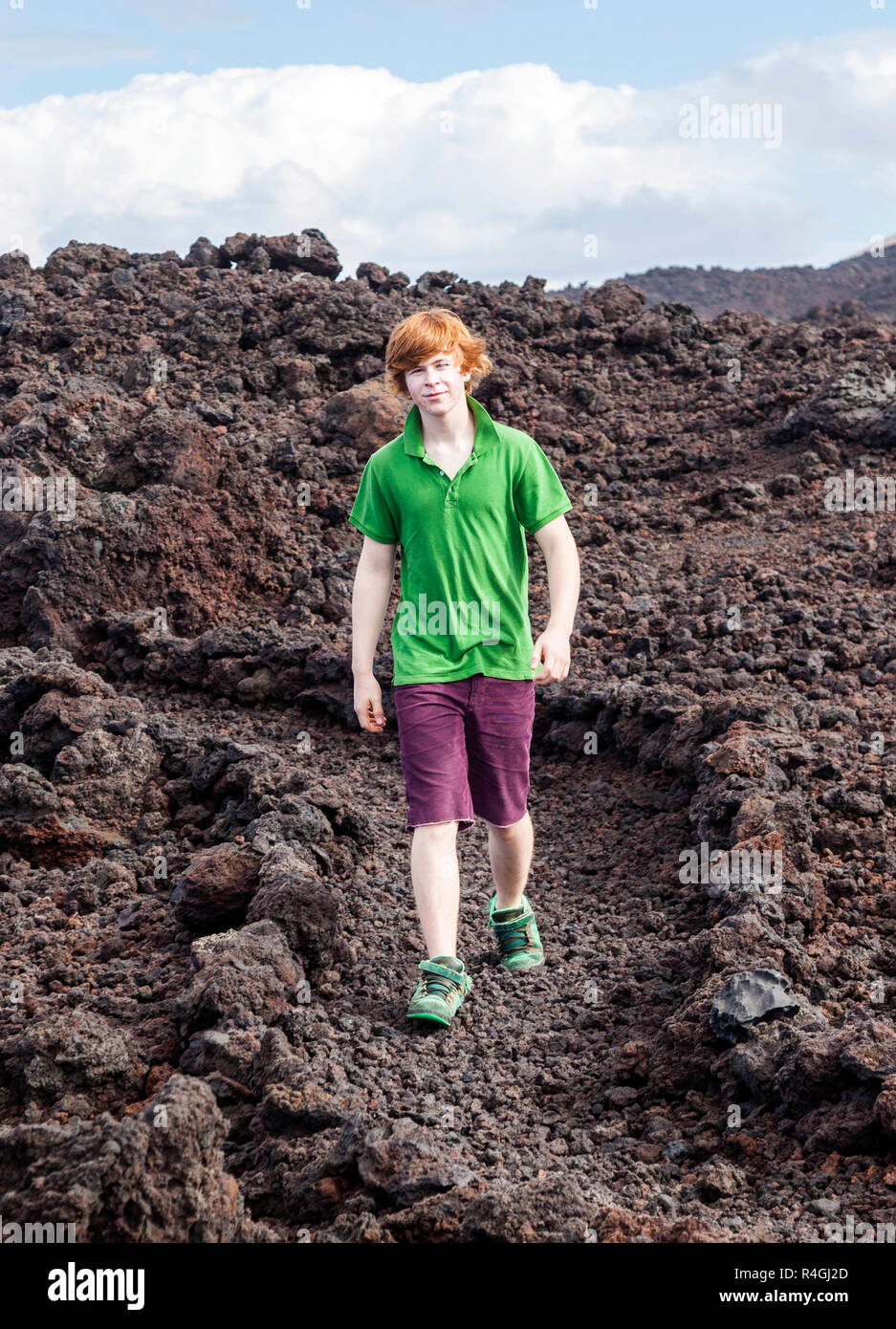 boy walking in volcanic area Stock Photo - Alamy