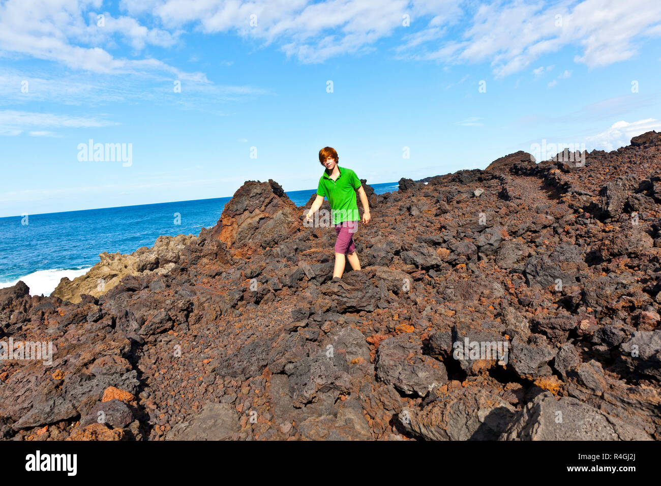 boy walking in volcanic area Stock Photo - Alamy