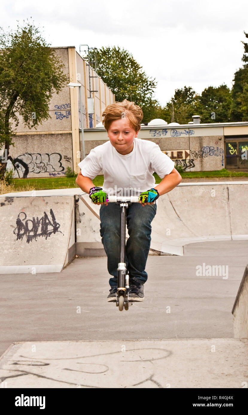 cute boy scooting with his scooter Stock Photo - Alamy