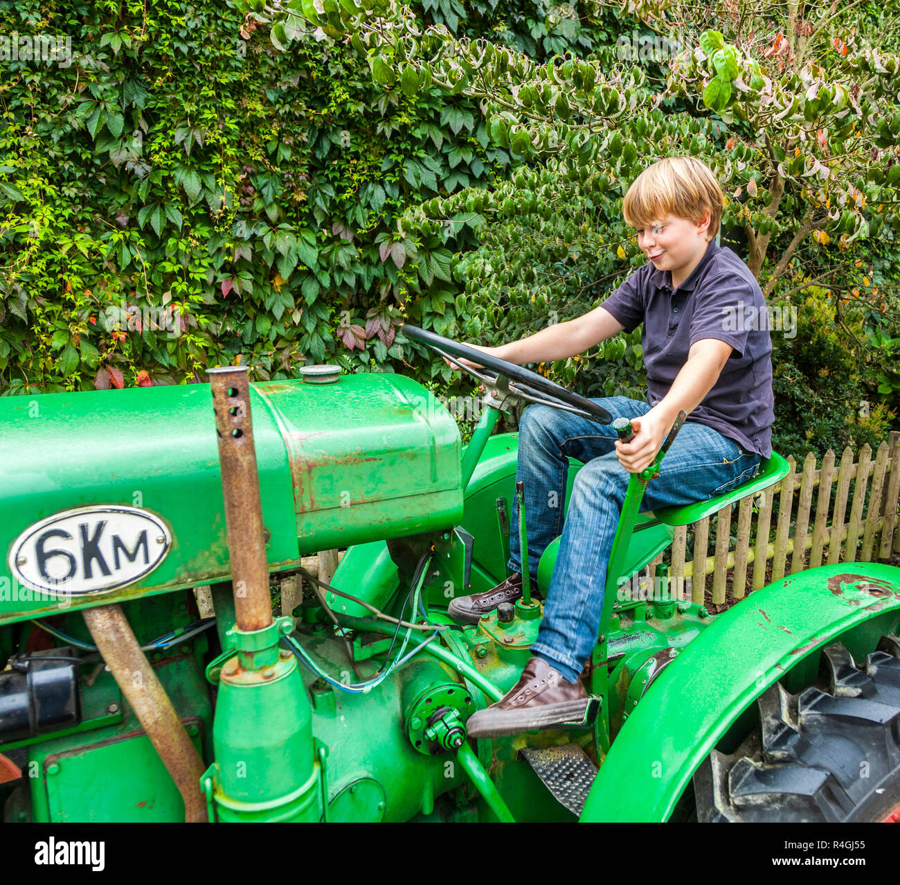 boy playing with an old tractor Stock Photo - Alamy